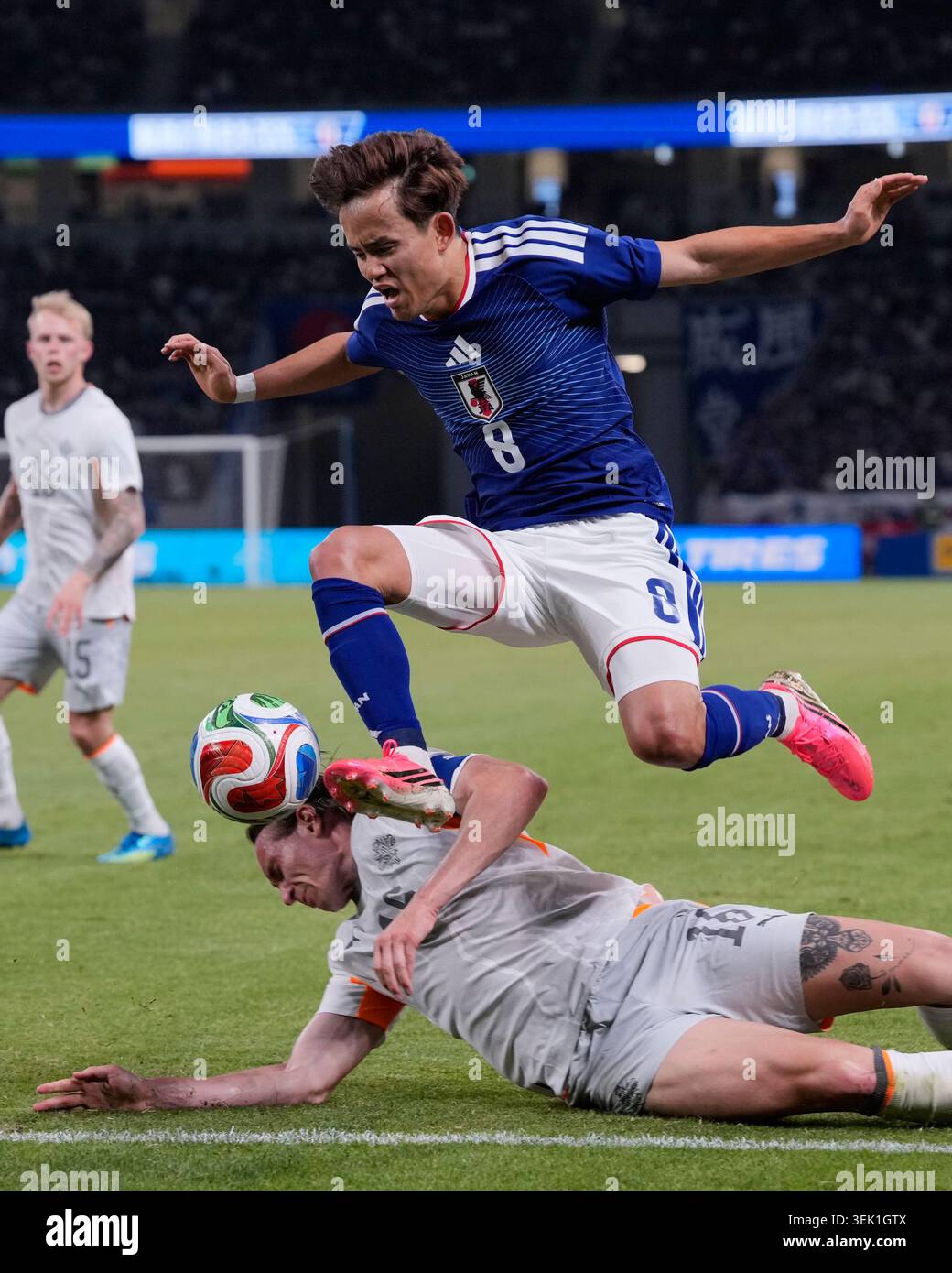 Takefusa Kubo of Japan leaps over Gisli Gottskalk Thordarson of Iceland ...