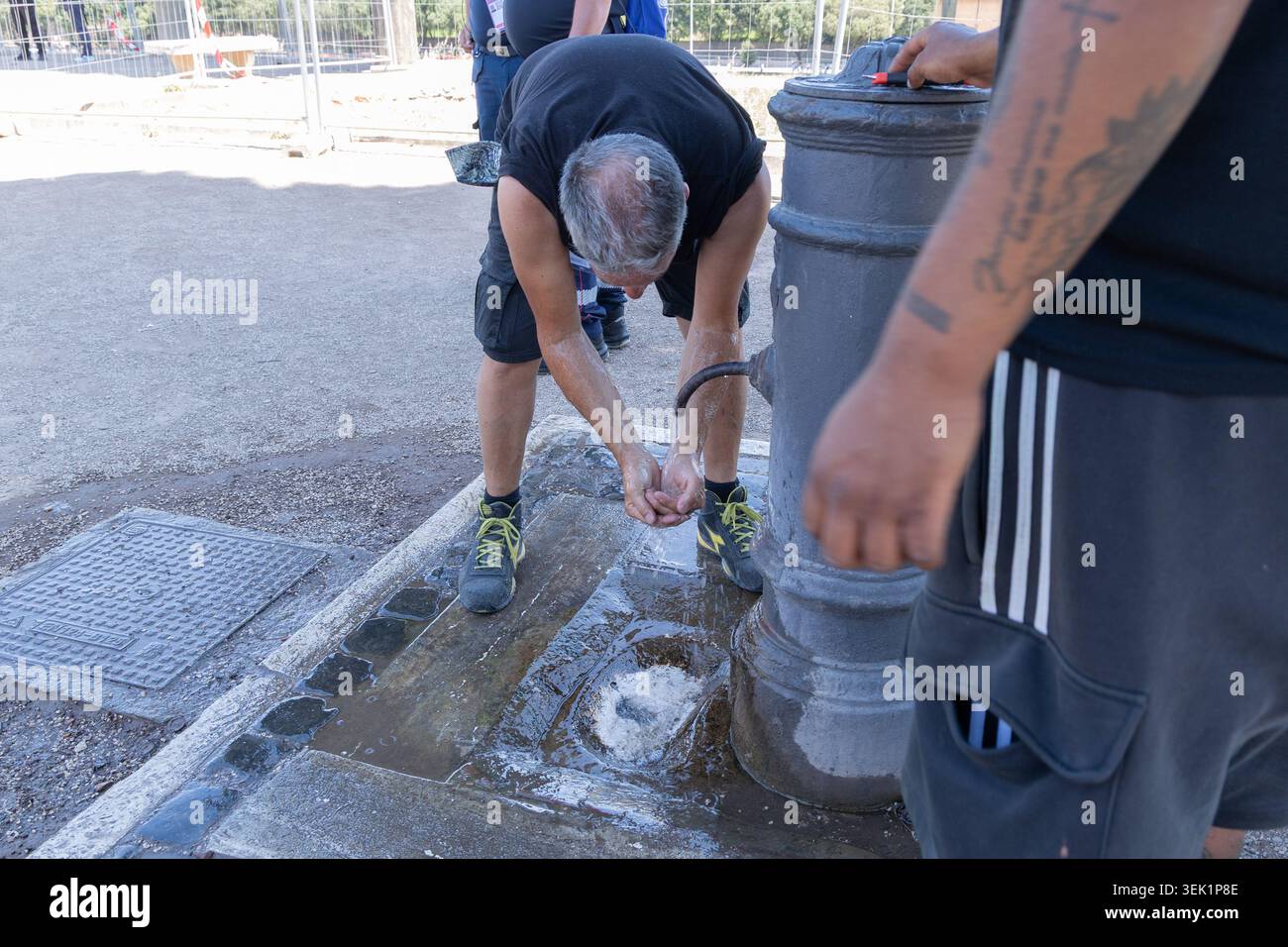 IPA85210030 - People seek refreshment at a drinking fountain at the ...