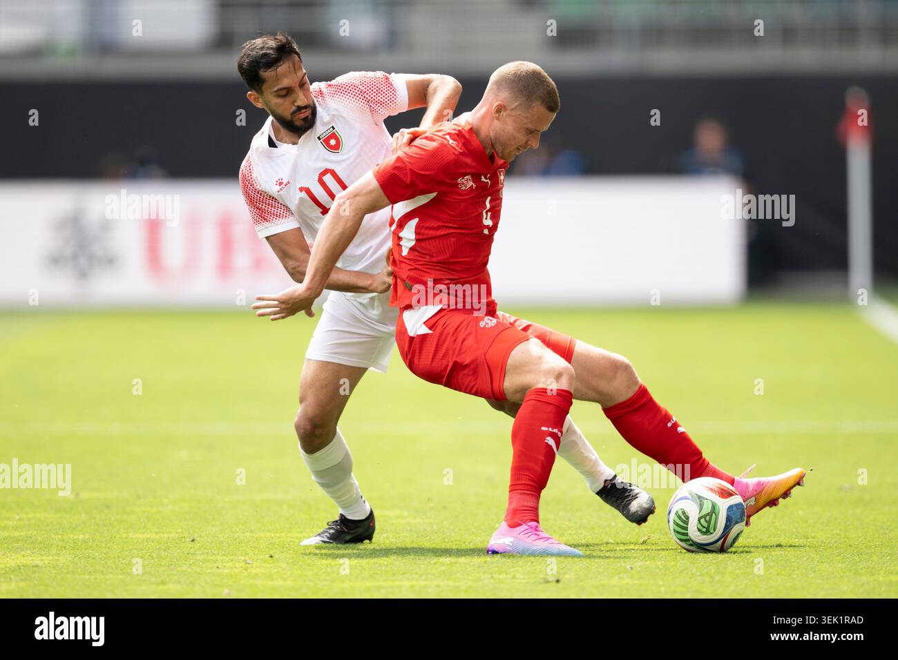 Jordan's Mousa Al-Tamari, left, and Switzerland's Nico Elvedi in action ...