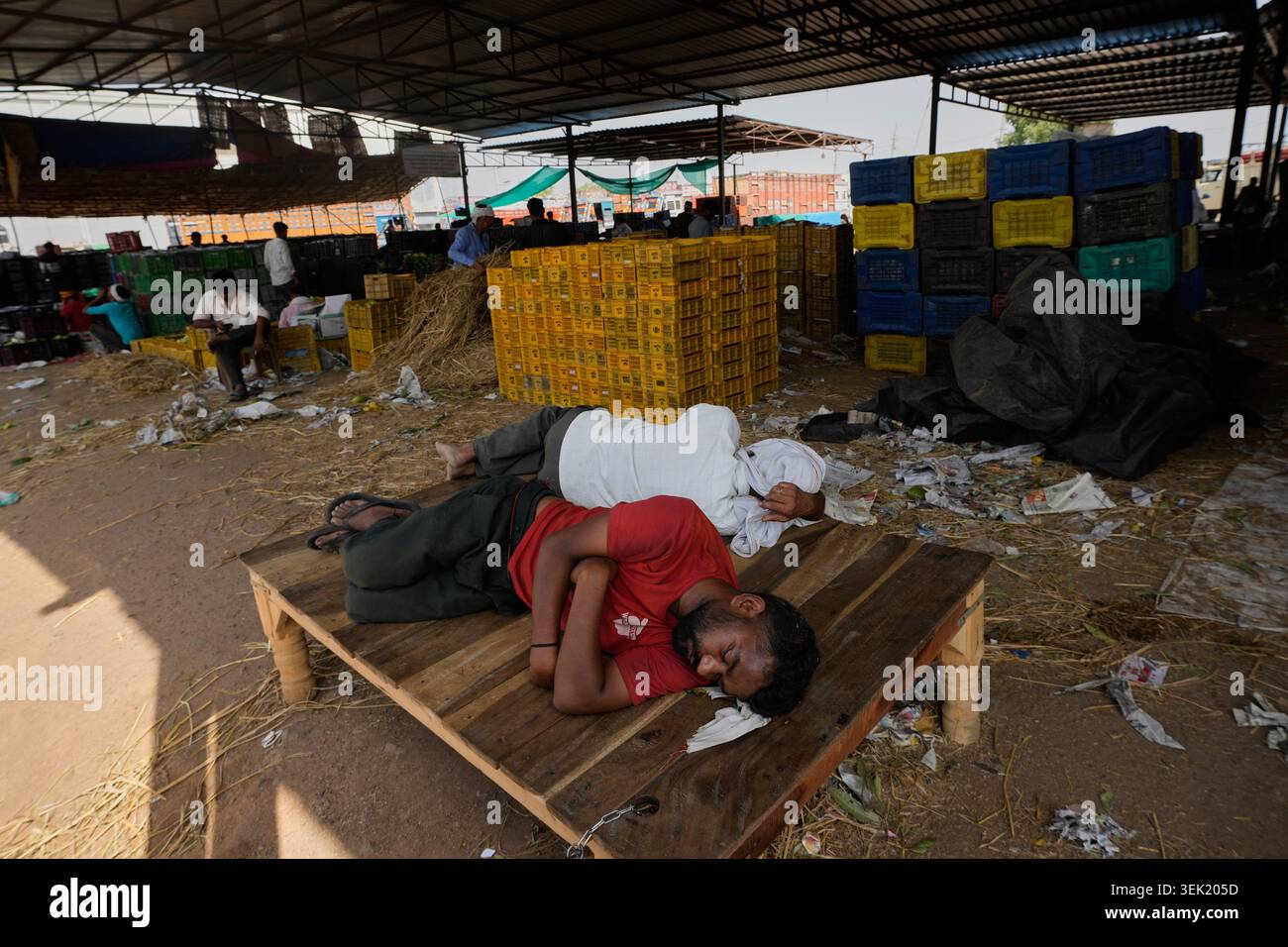 People sleep at a wholesale fruit market during a hot summer day on the ...