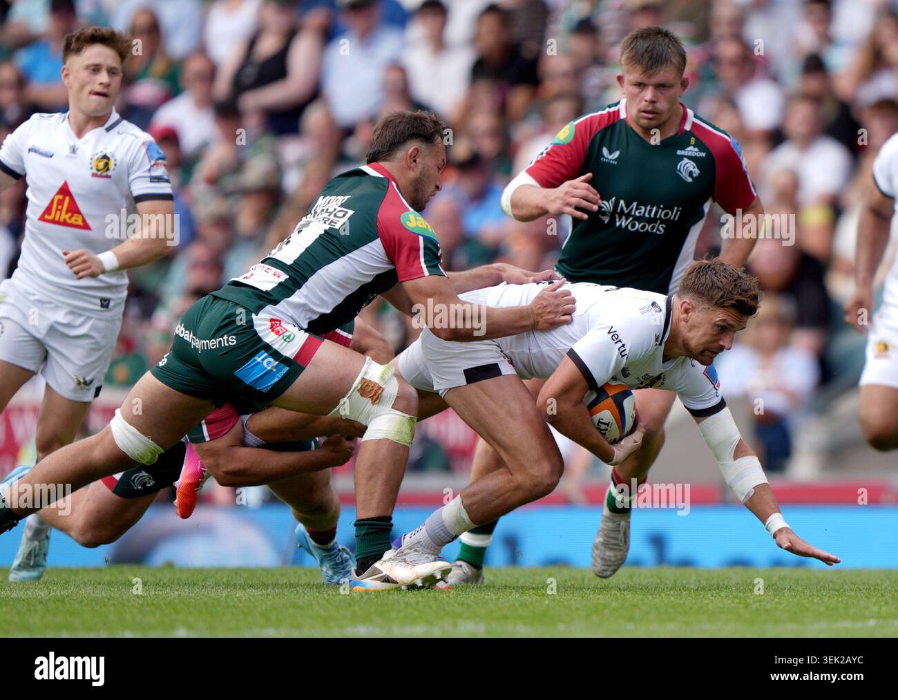 Exeter's Henry Slade is tackled by Leicester's Greg Fisilau during the ...