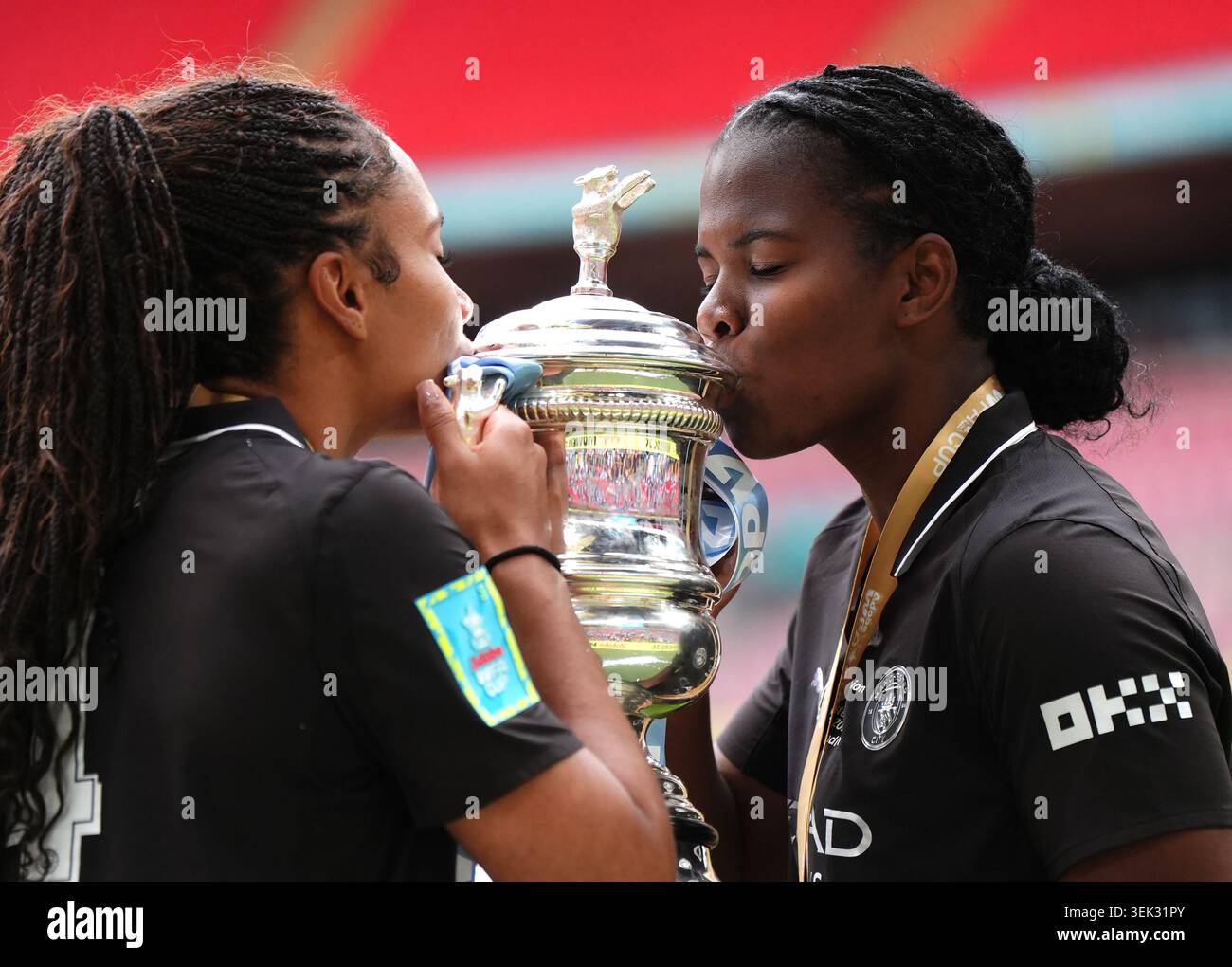 Manchester City's Jade Rose (left) and Khadija Shaw kiss the trophy ...