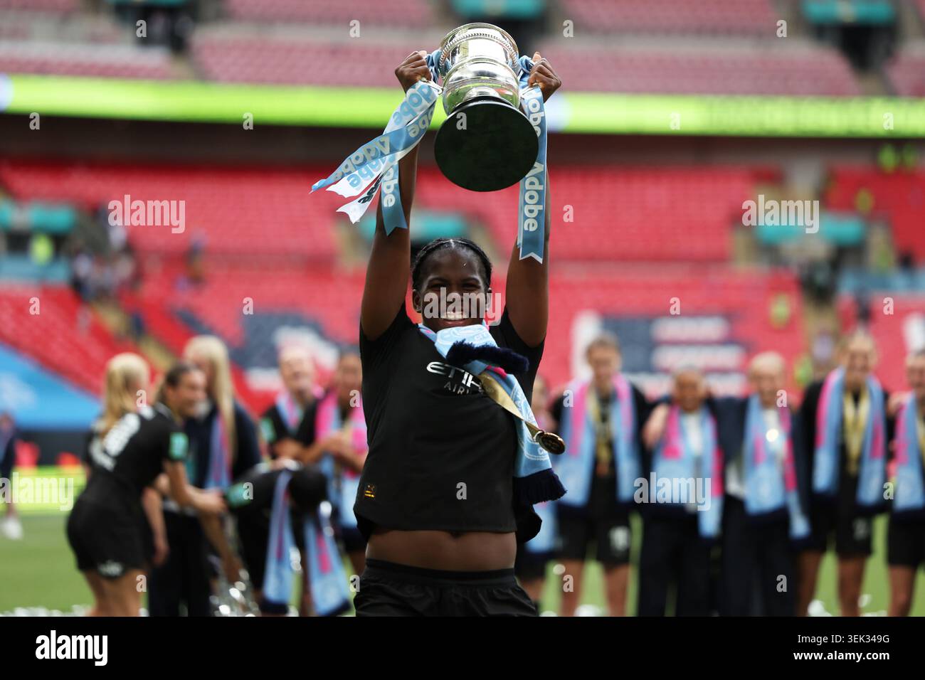 Khadija Shaw of Manchester City lifts the trophy after winning the ...