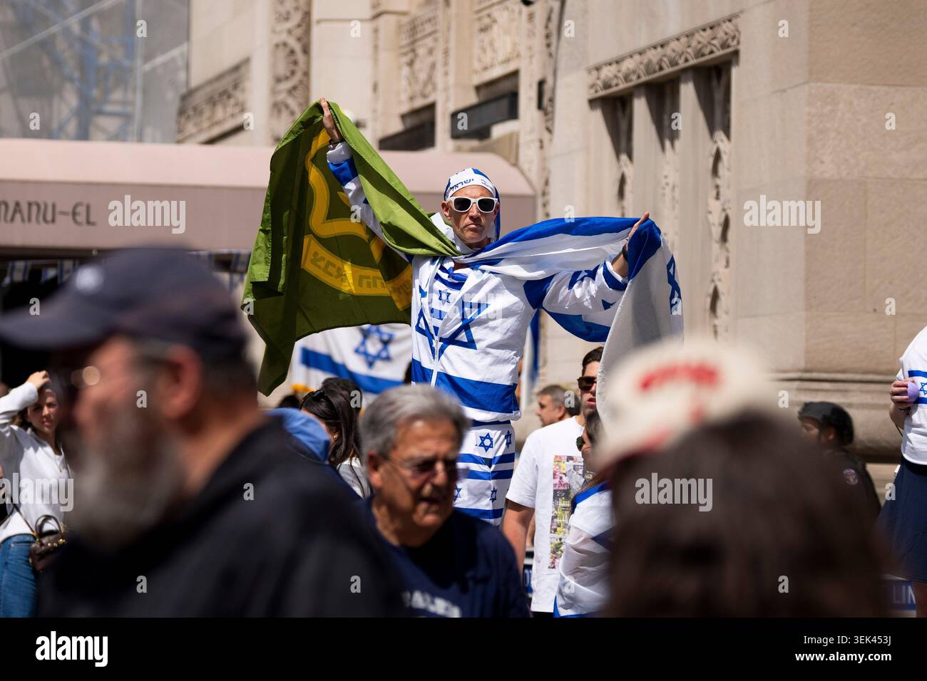 Joseph Shatzkes waves Israeli flags in the crowd during the Israel Day ...