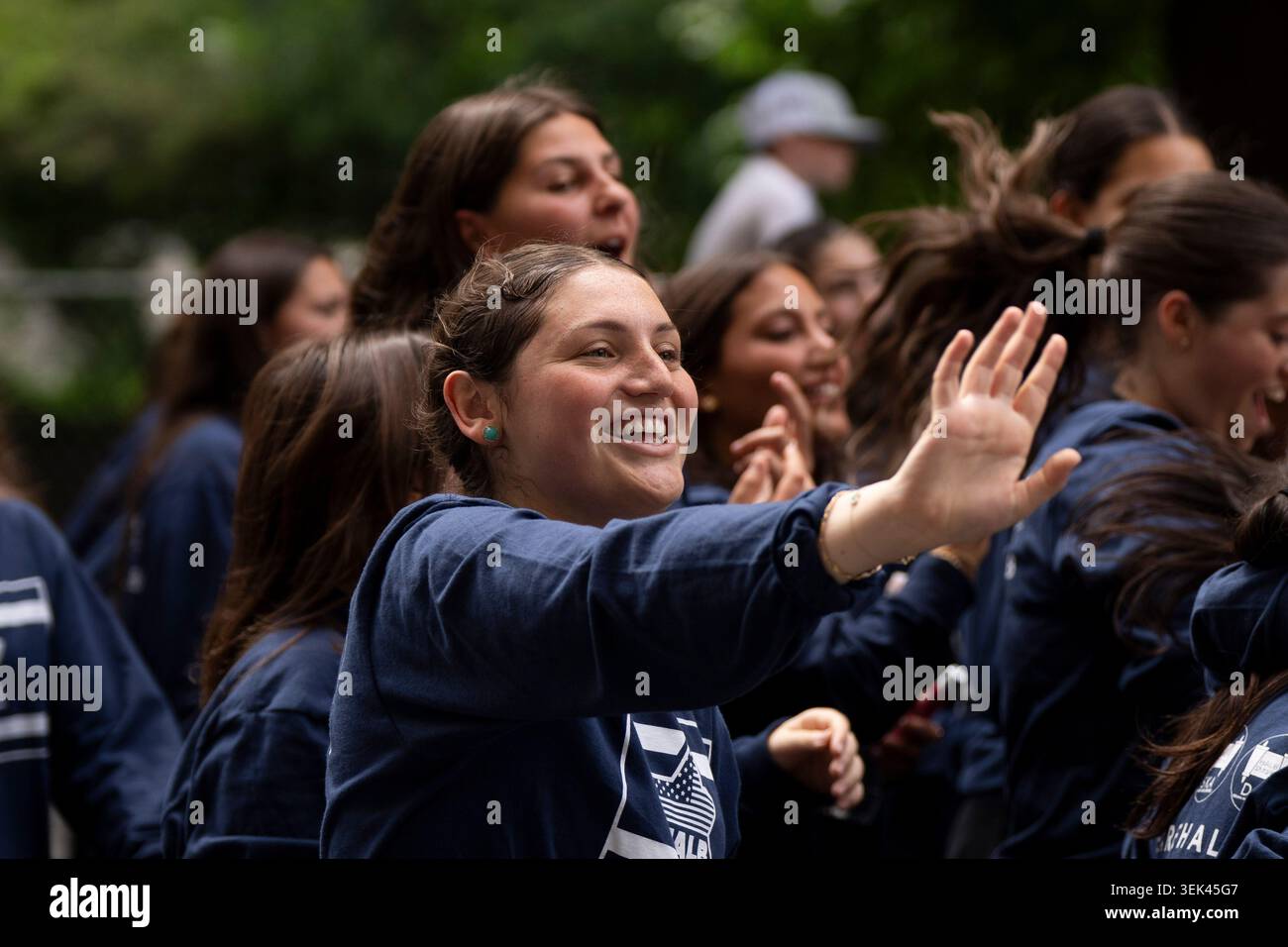A parade participant waves at the crowd during the Israel Day Parade ...