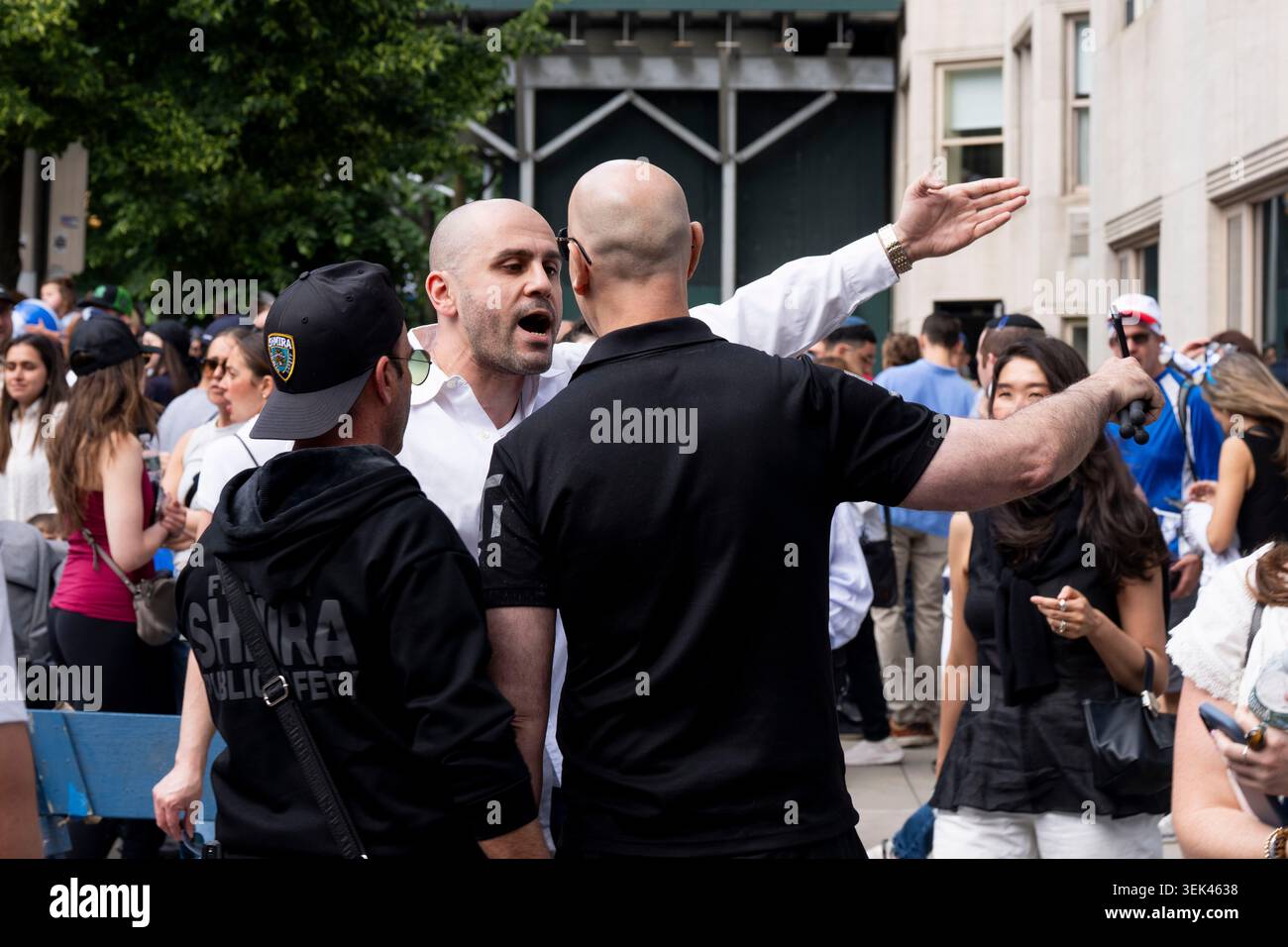 Two spectators get into an argument during the Israel Day Parade ...