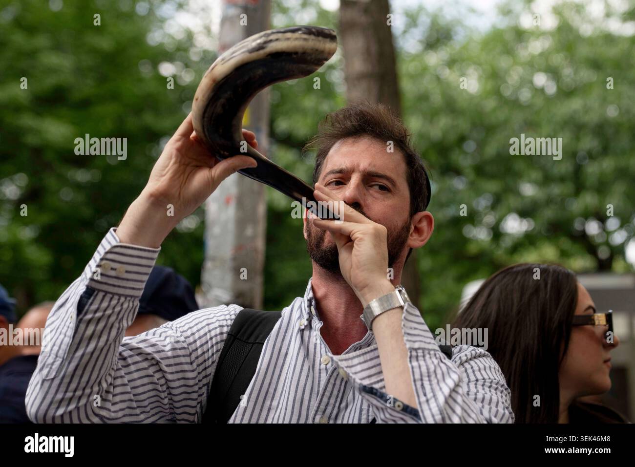 Joseph Volgel blows a traditional shofar, a ram horn, during the Israel ...