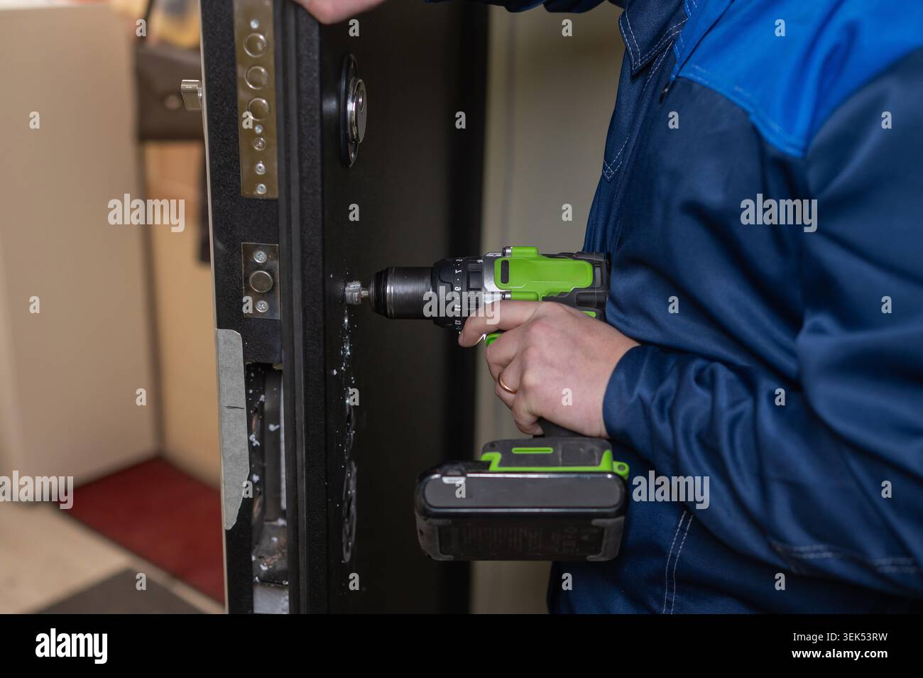 The technician installs a smart electronic lock on the front door Stock ...