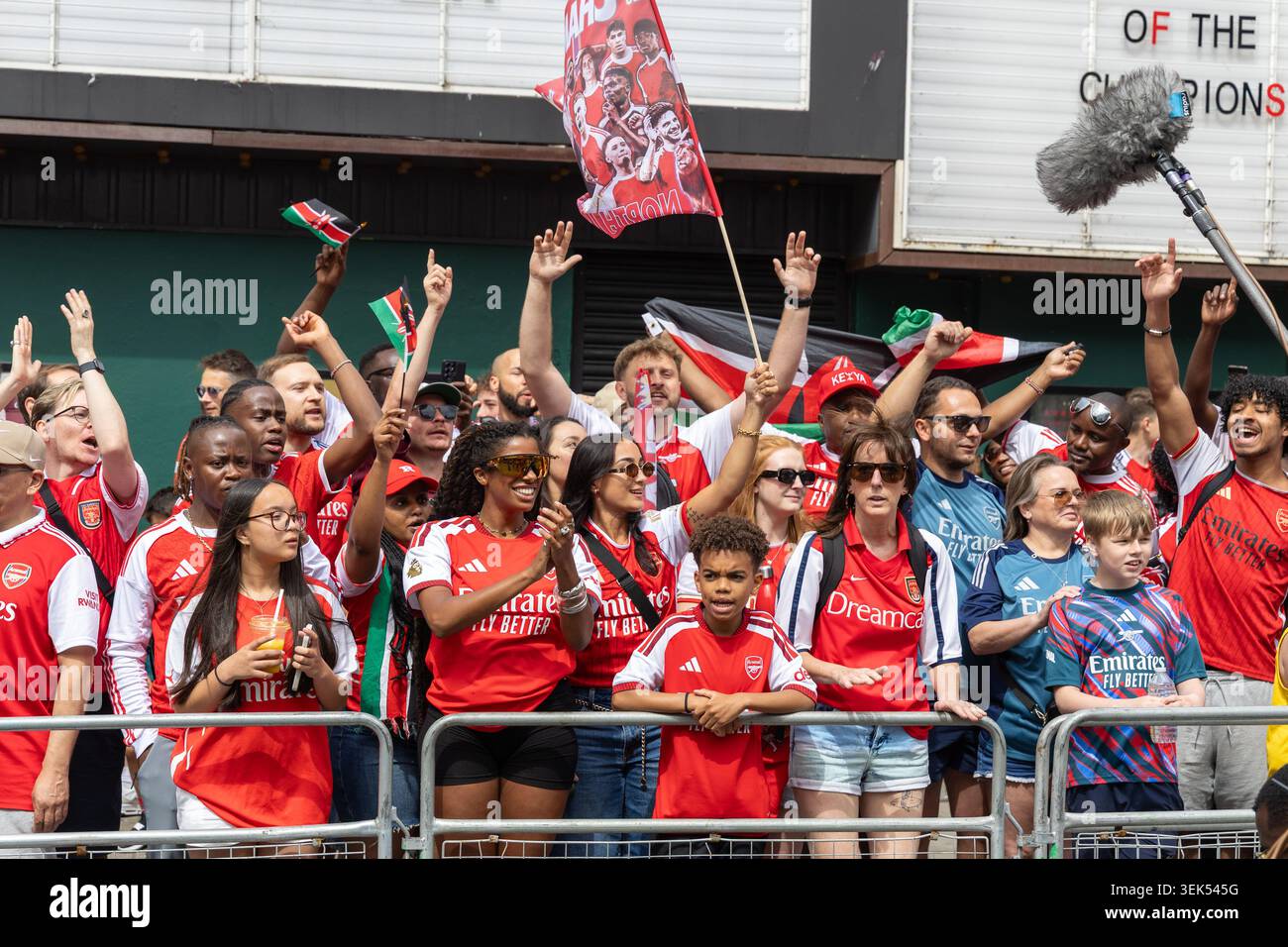 Arsenal fans celebrate on the side of the street as they wait for the ...