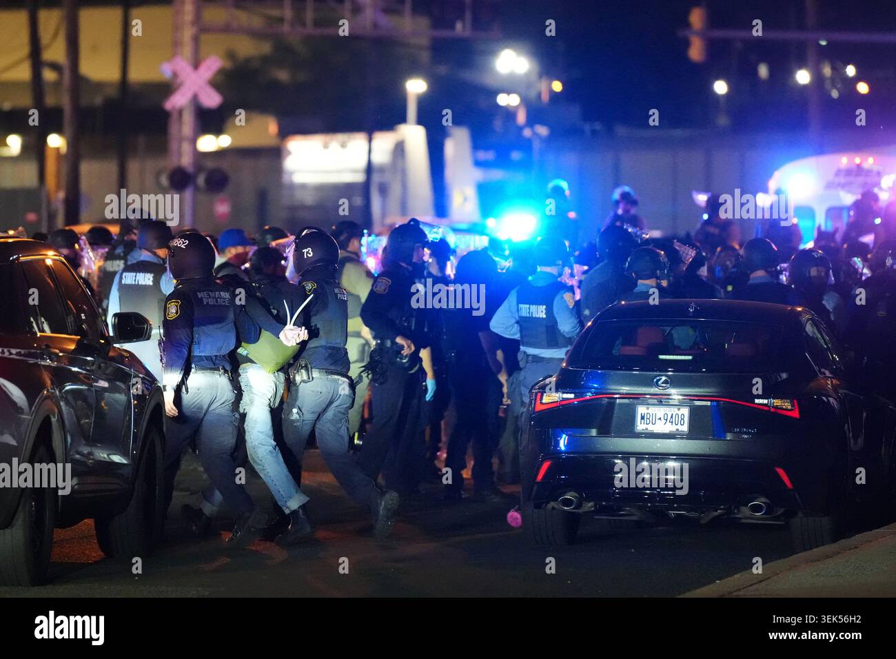 Law enforcement officers detain protesters outside Delaney Hall ...
