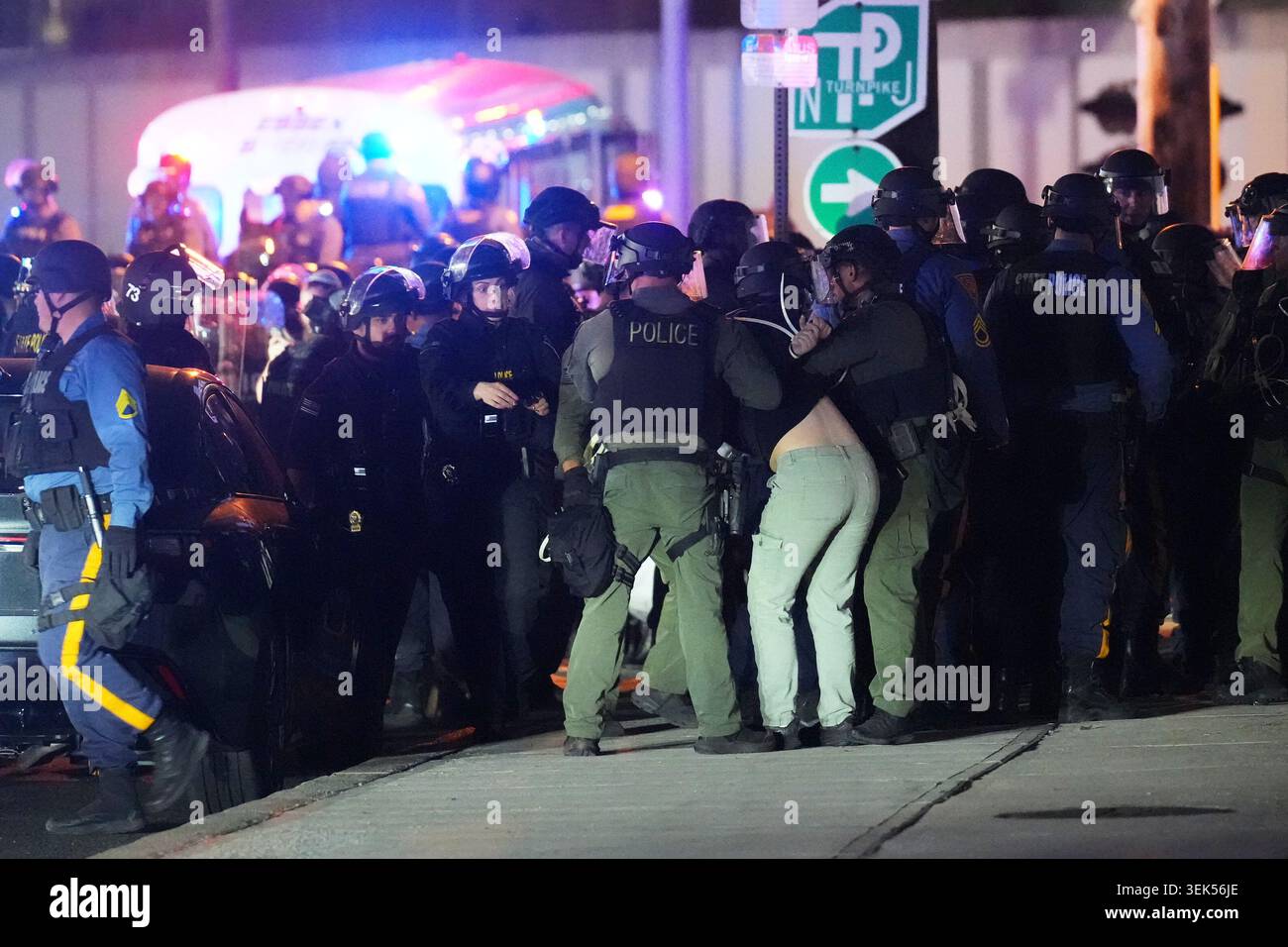 Law enforcement officers detain protesters outside Delaney Hall ...