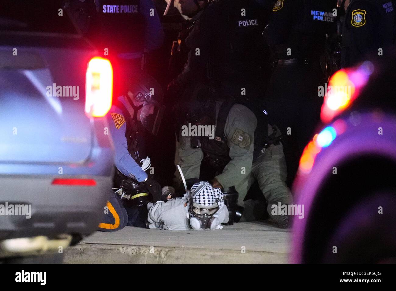 Law enforcement officers detain a protester outside Delaney Hall ...