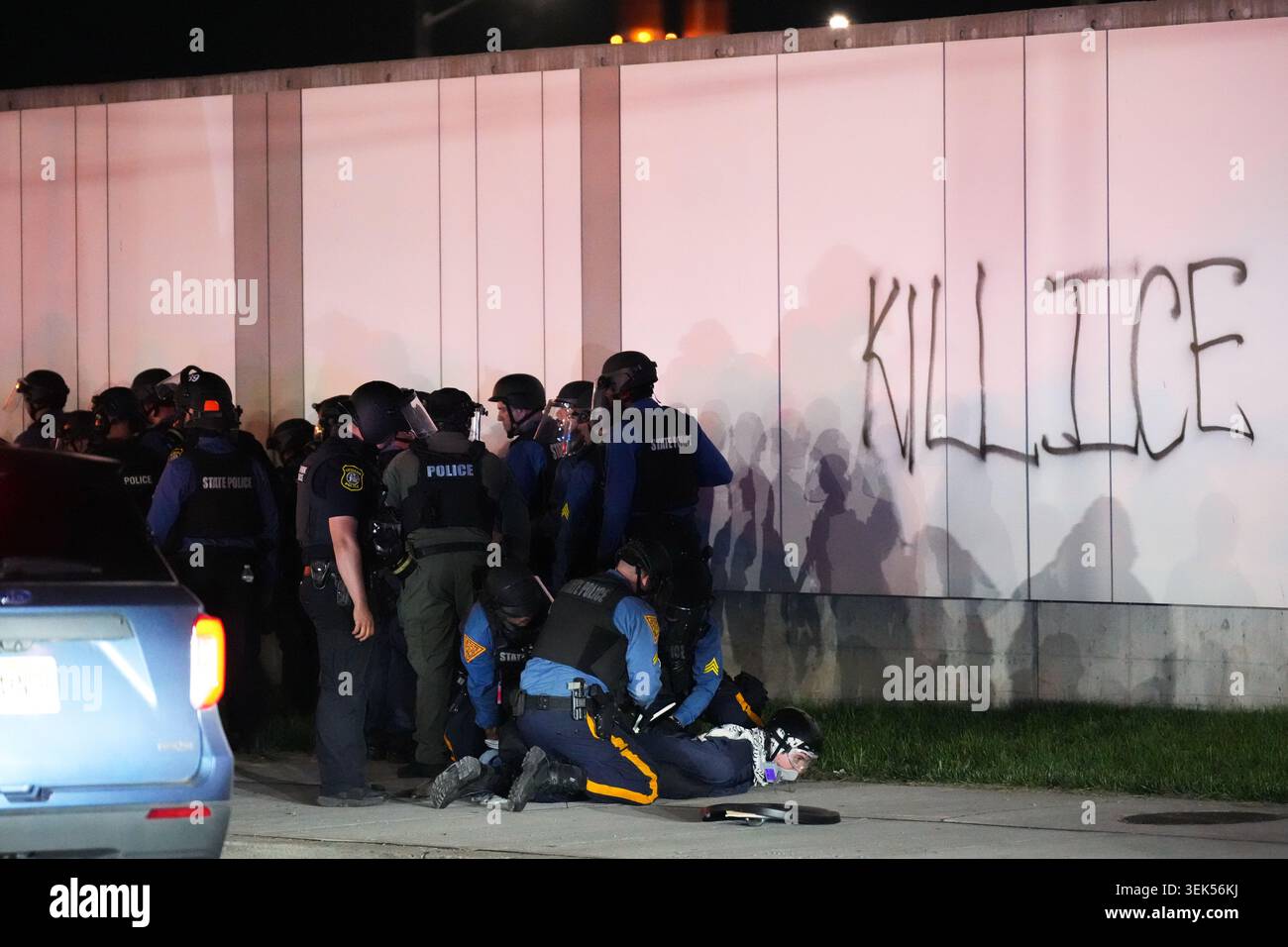Law enforcement officers detain a protester outside Delaney Hall ...