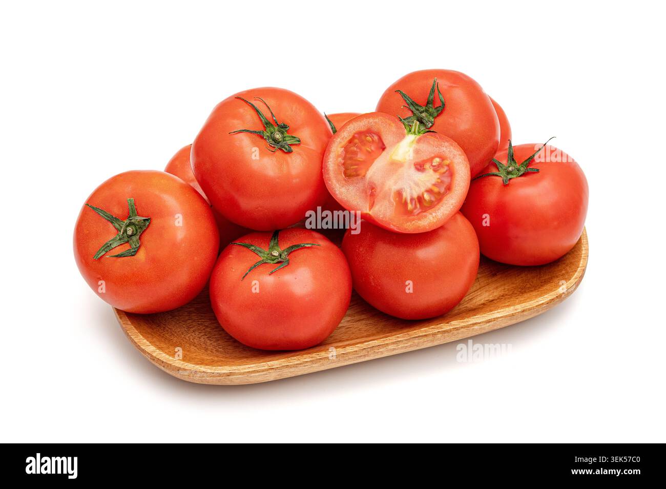 Fresh red tomatoes with a half slice on a wooden tray isolated on white ...