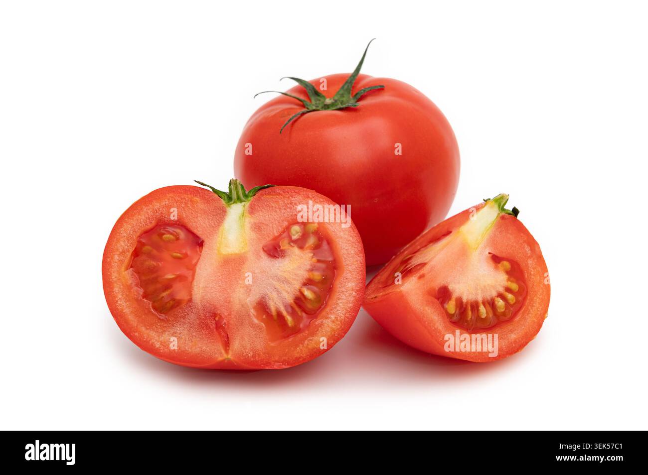 Whole tomato with half and a quarter slice isolated on white background ...