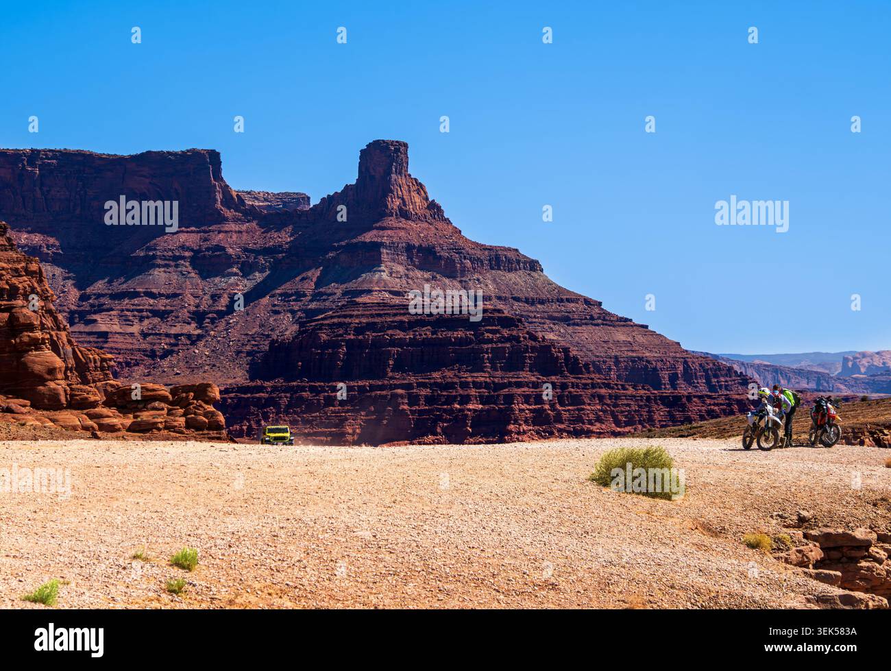 Moab, Utah May 15 2026 Two cyclists take a break on a plateau adjacent ...
