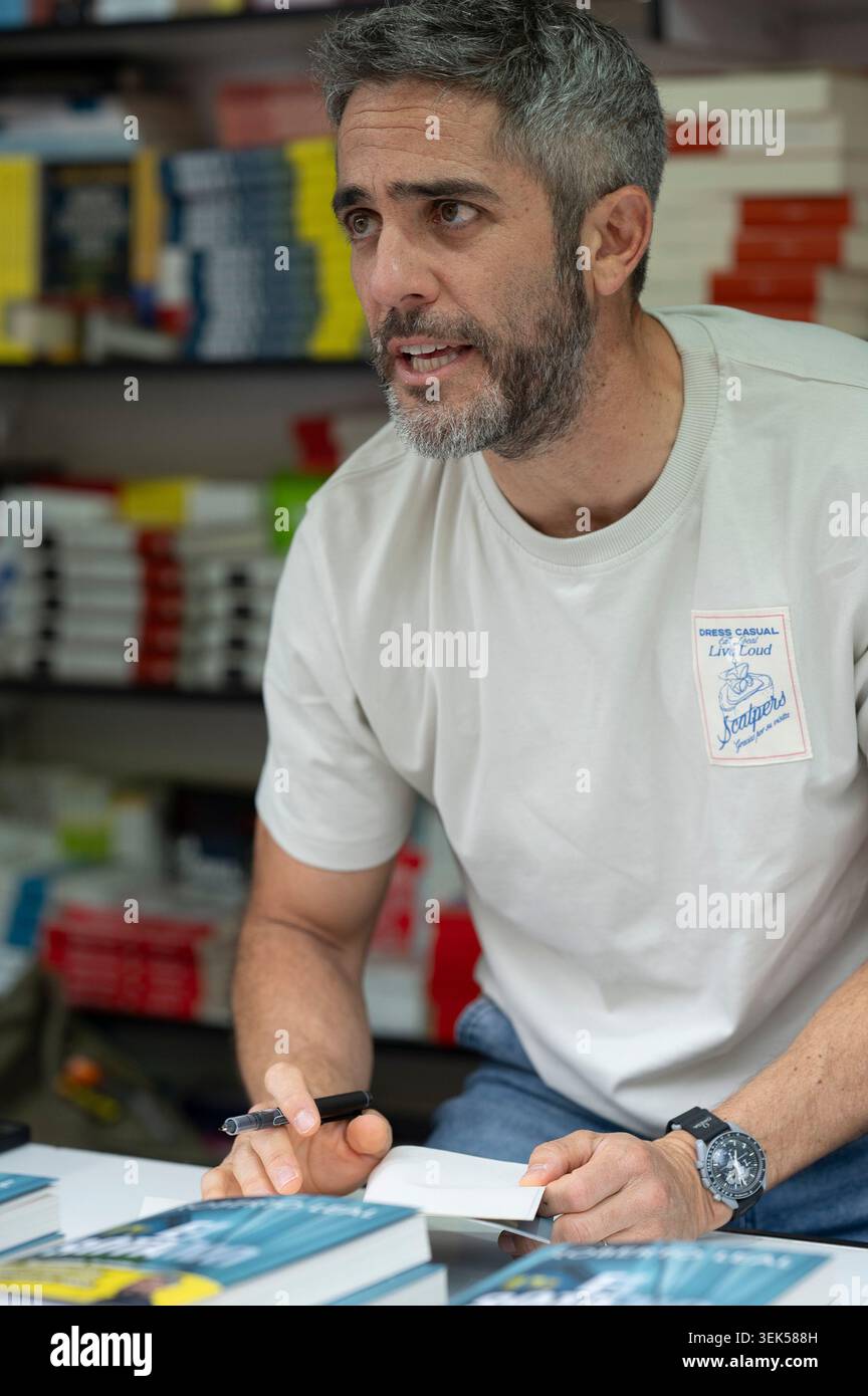 Author Roberto Leal signs copies of her books during the 85th edition ...