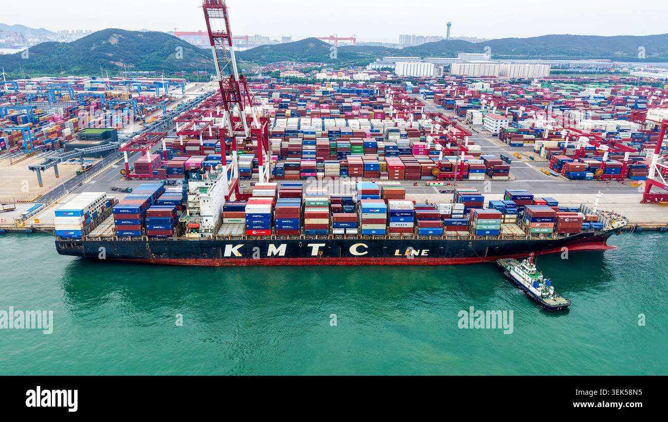 Workers handle cargo at Qingdao Port in east China's Shandong Province ...