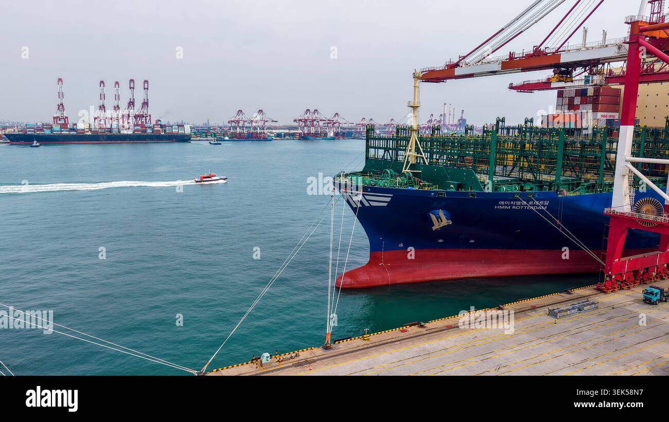 Workers handle cargo at Qingdao Port in east China's Shandong Province ...