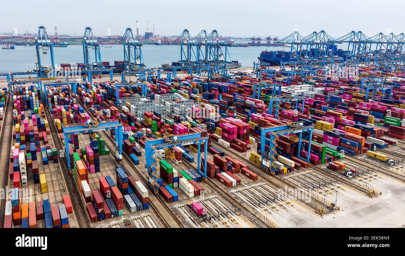 Workers handle cargo at Qingdao Port in east China's Shandong Province ...