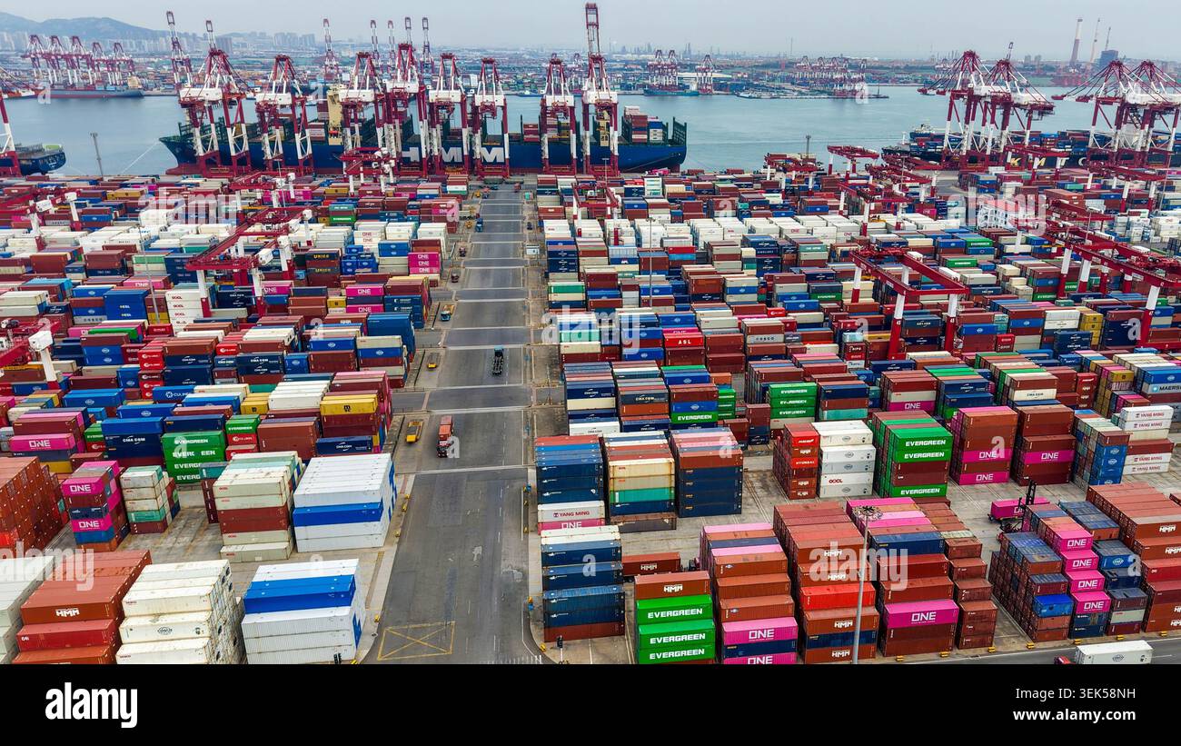 Workers handle cargo at Qingdao Port in east China's Shandong Province ...