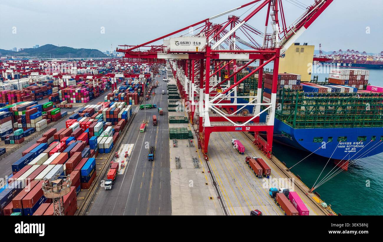 Workers handle cargo at Qingdao Port in east China's Shandong Province ...