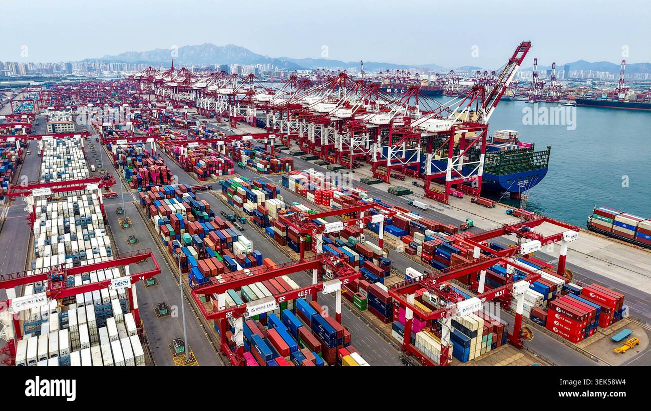 Workers handle cargo at Qingdao Port in east China's Shandong Province ...