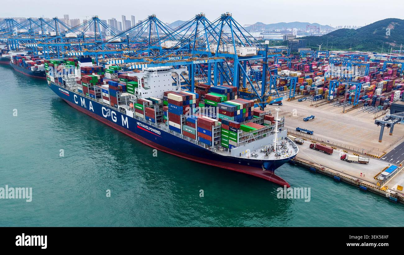 Workers handle cargo at Qingdao Port in east China's Shandong Province ...