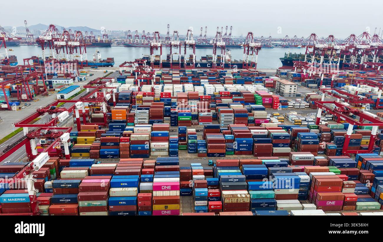 Workers handle cargo at Qingdao Port in east China's Shandong Province ...