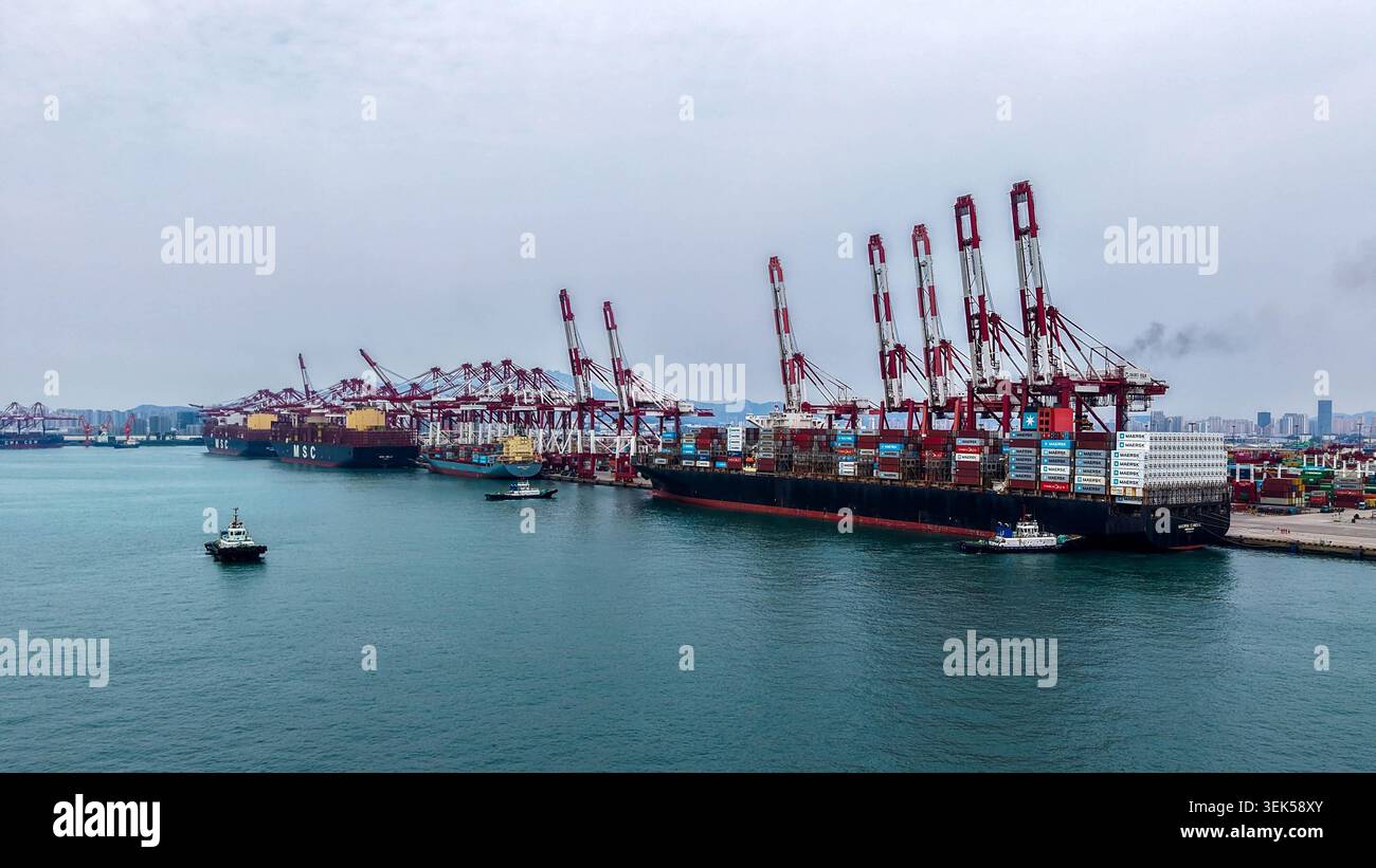 Workers handle cargo at Qingdao Port in east China's Shandong Province ...