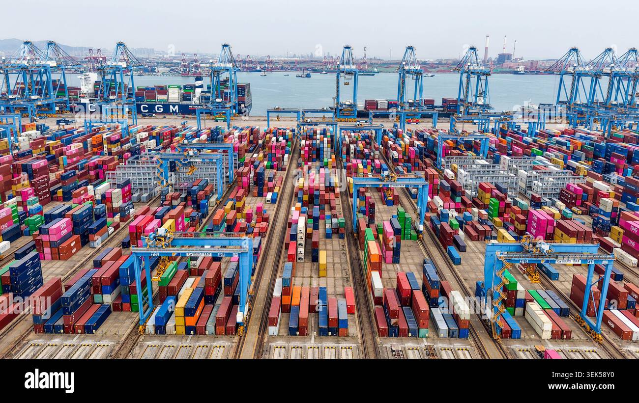 Workers handle cargo at Qingdao Port in east China's Shandong Province ...