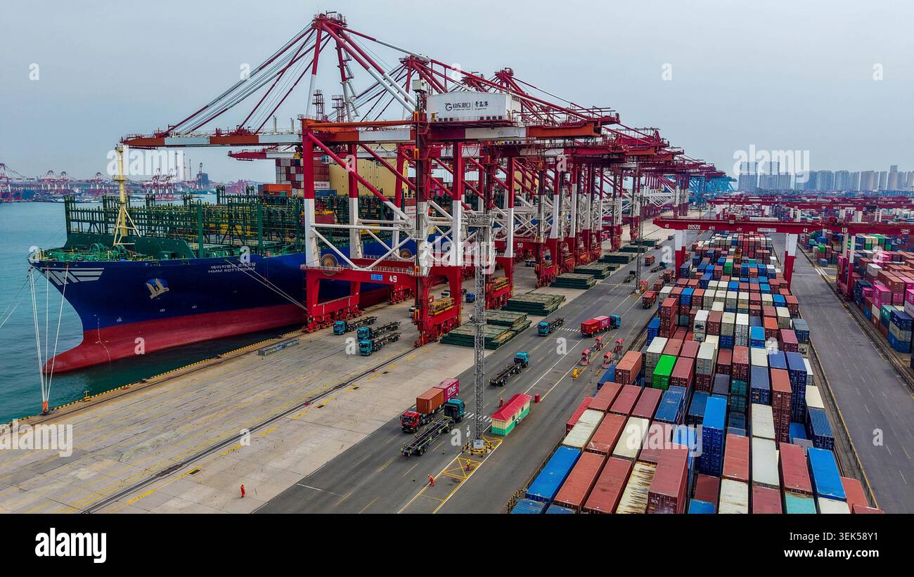 Workers handle cargo at Qingdao Port in east China's Shandong Province ...