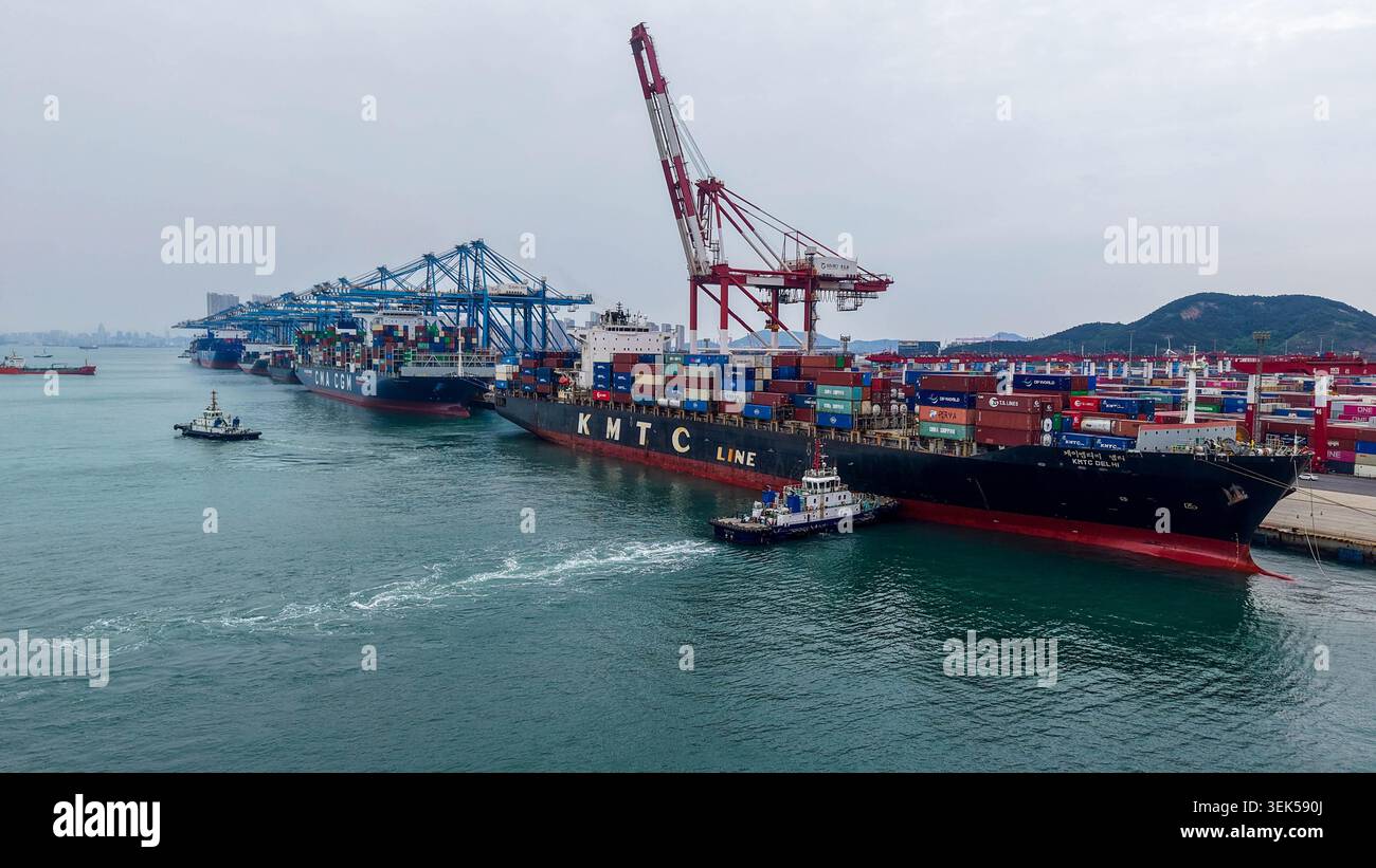 Workers handle cargo at Qingdao Port in east China's Shandong Province ...