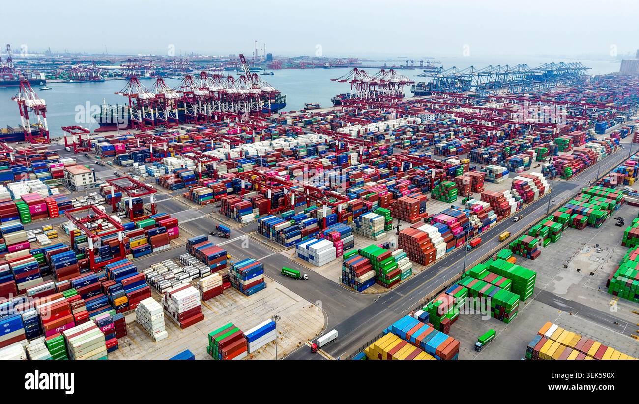 Workers handle cargo at Qingdao Port in east China's Shandong Province ...