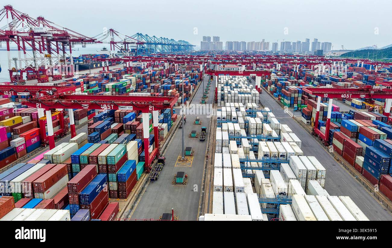 Workers handle cargo at Qingdao Port in east China's Shandong Province ...
