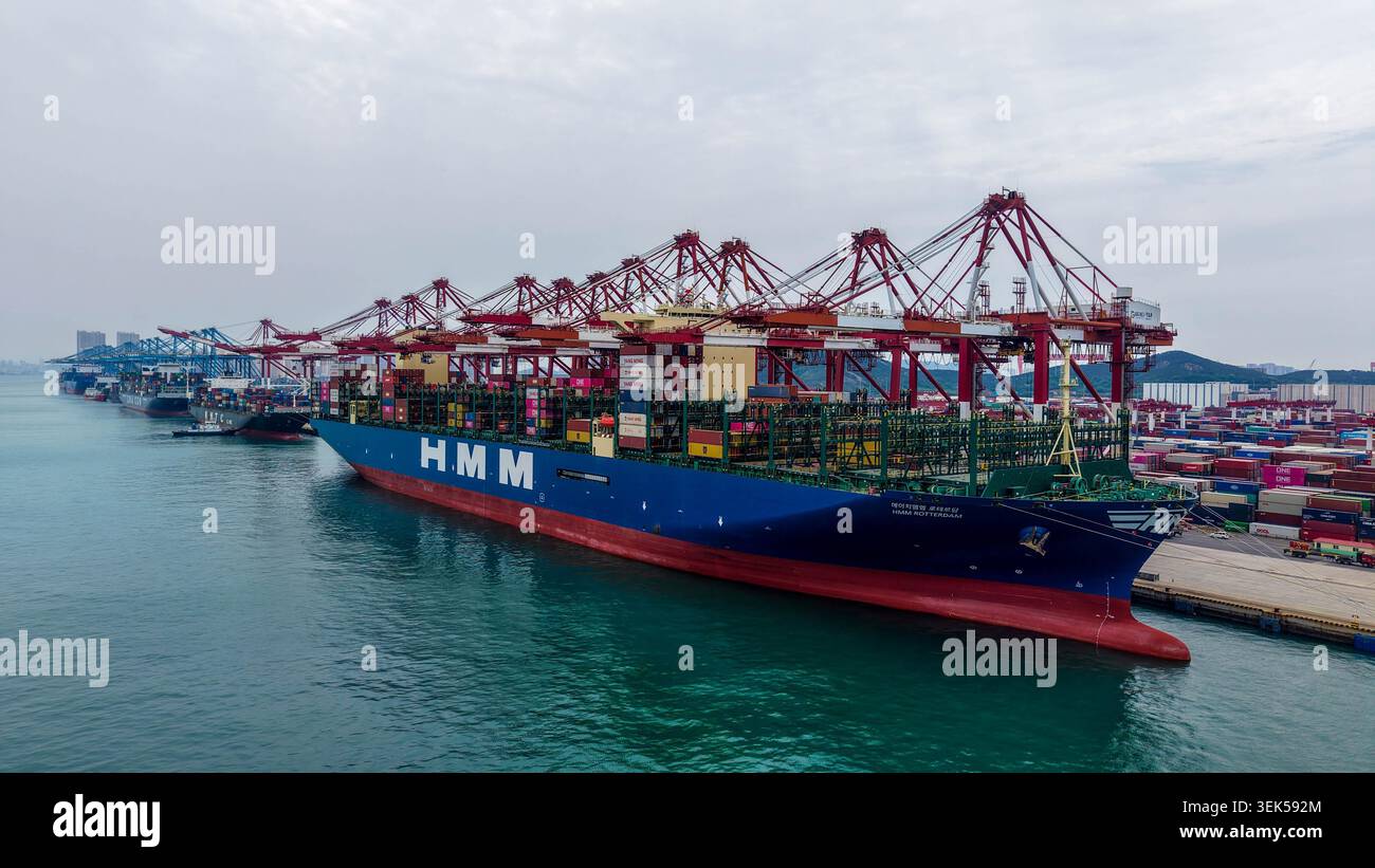 Workers handle cargo at Qingdao Port in east China's Shandong Province ...