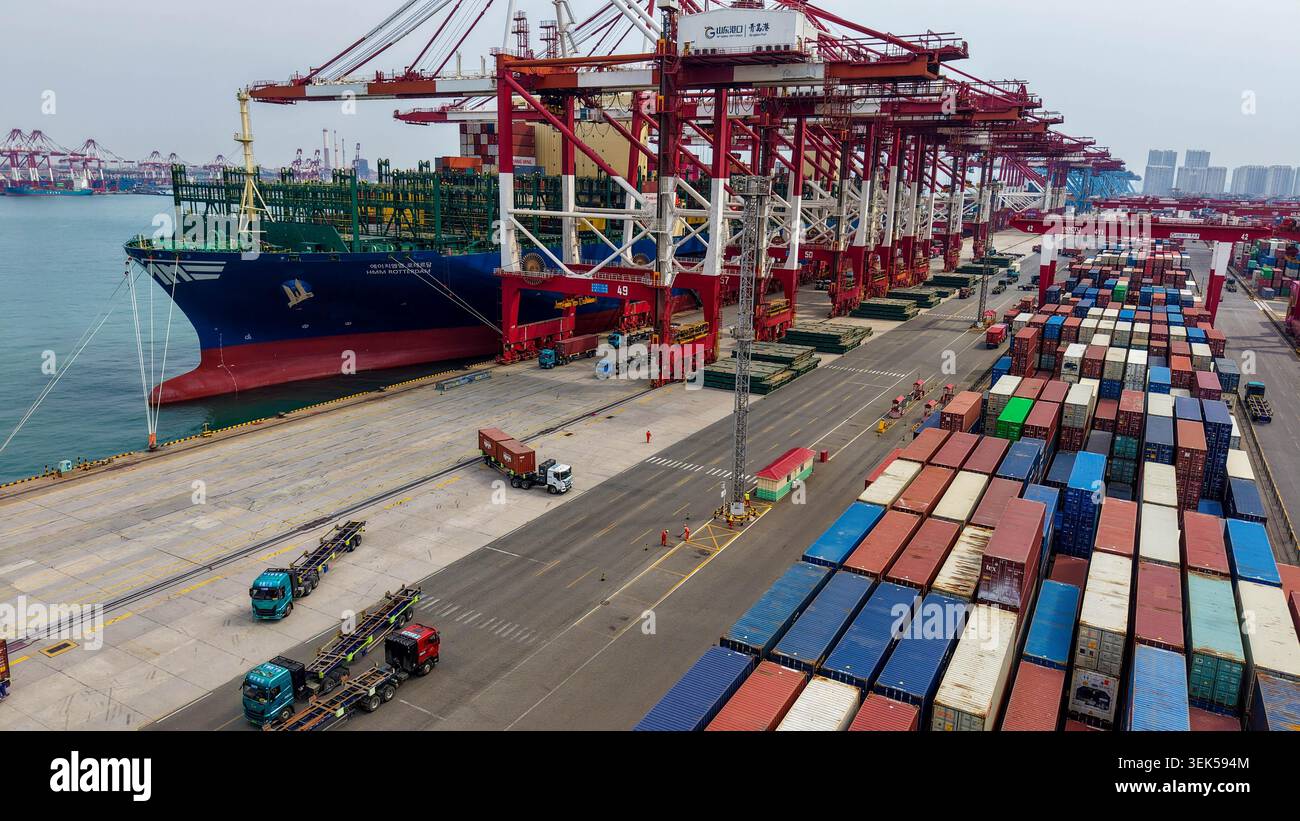 Workers handle cargo at Qingdao Port in east China's Shandong Province ...