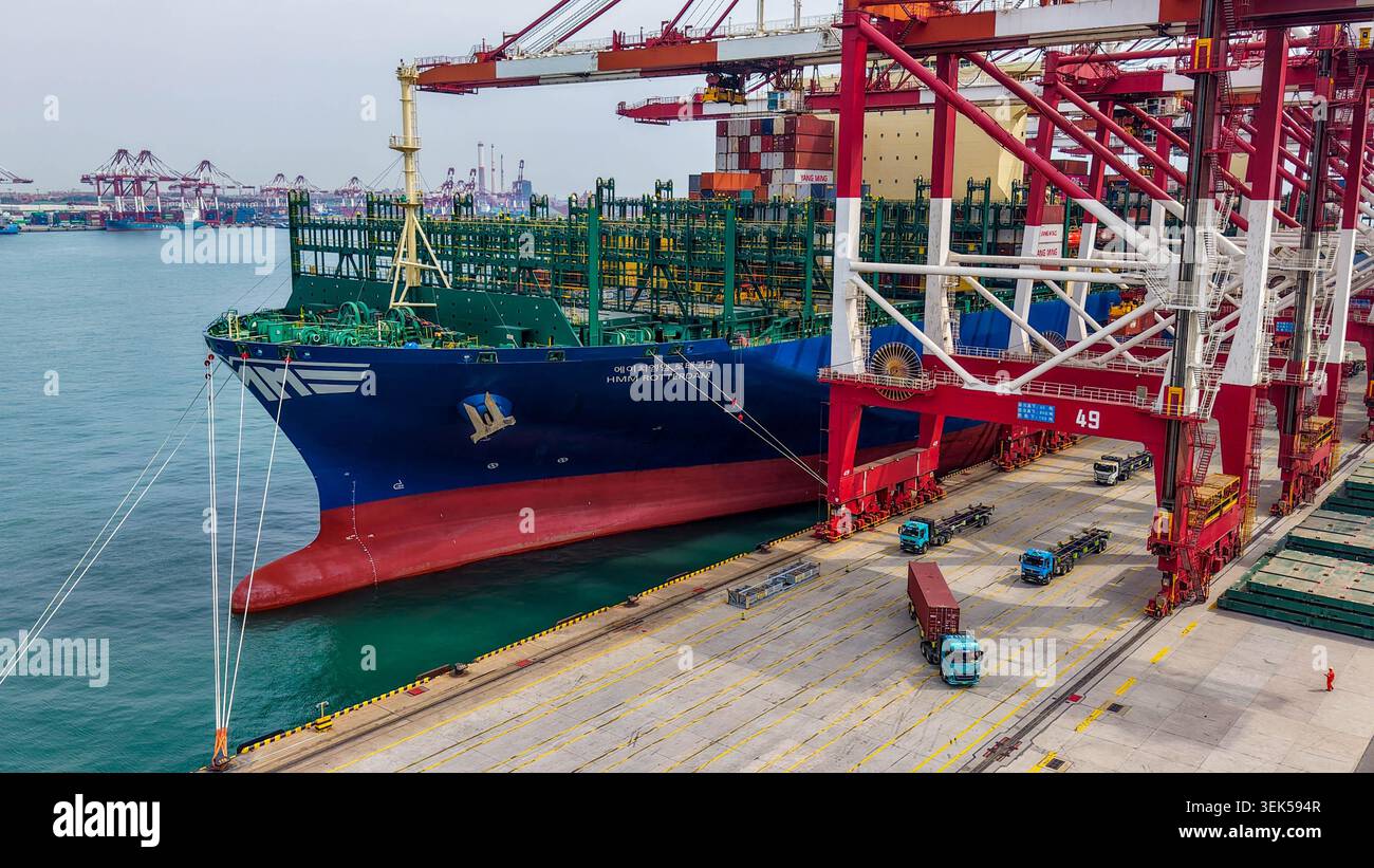 Workers handle cargo at Qingdao Port in east China's Shandong Province ...