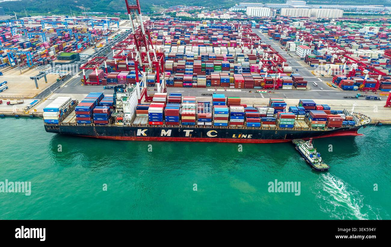 Workers handle cargo at Qingdao Port in east China's Shandong Province ...