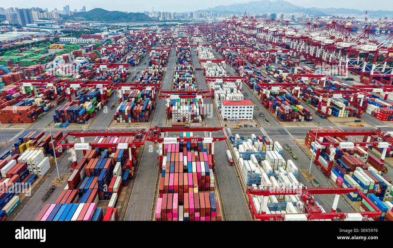 Workers handle cargo at Qingdao Port in east China's Shandong Province ...
