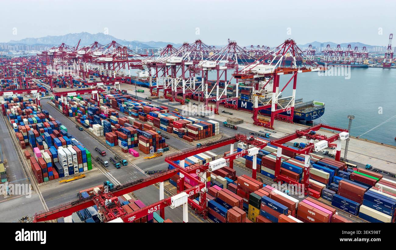 Workers handle cargo at Qingdao Port in east China's Shandong Province ...