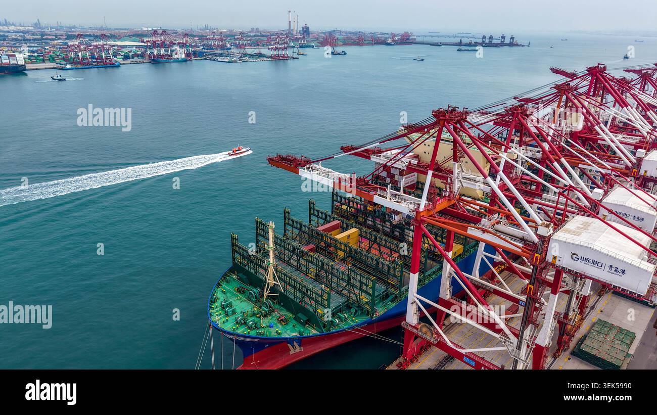 Workers handle cargo at Qingdao Port in east China's Shandong Province ...