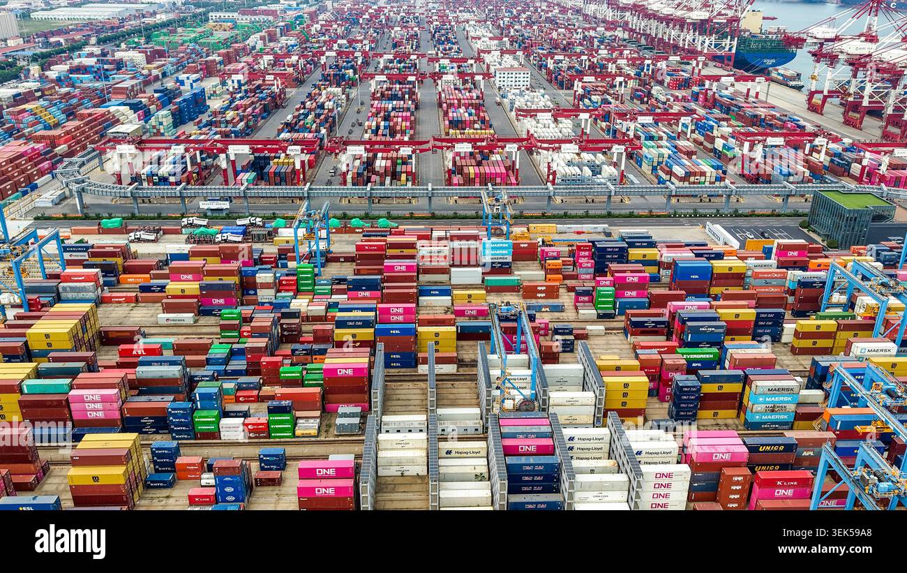 Workers handle cargo at Qingdao Port in east China's Shandong Province ...