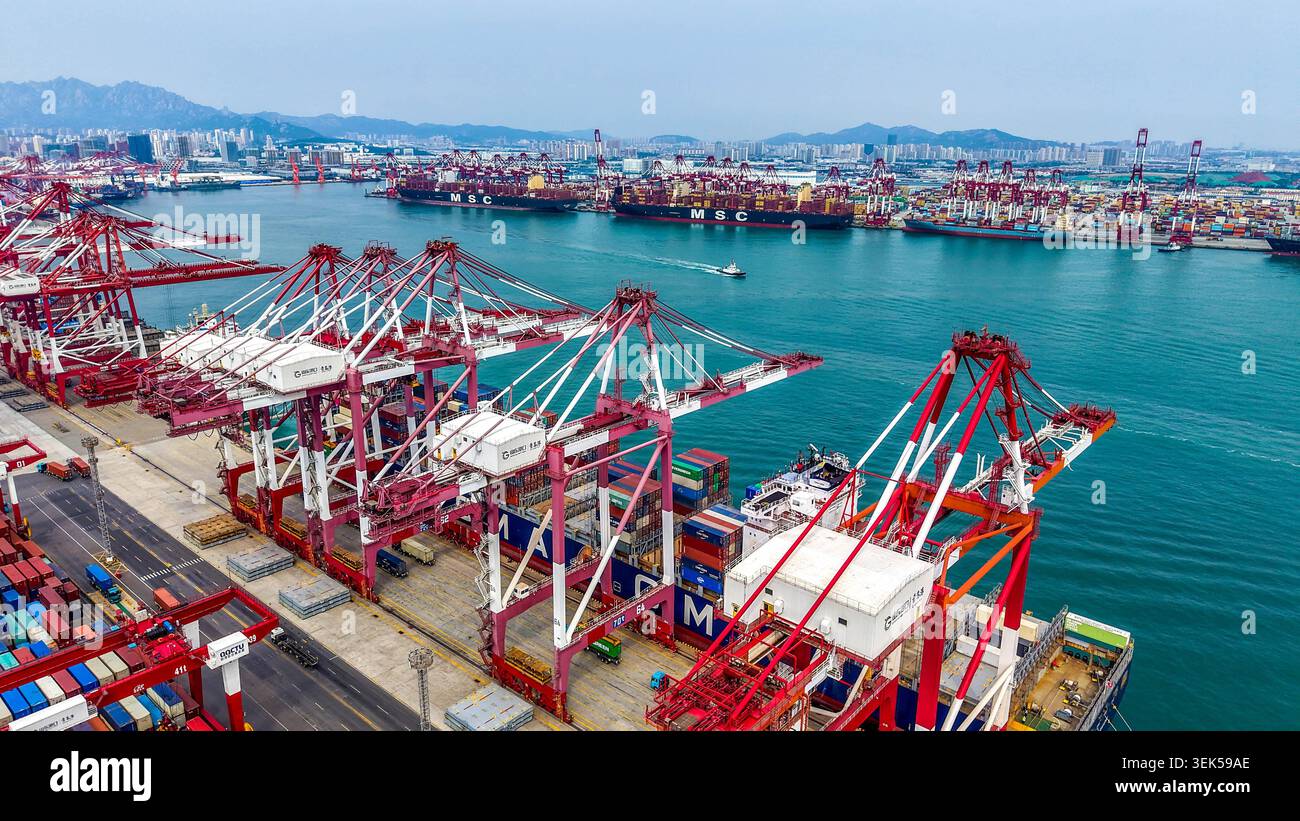Workers handle cargo at Qingdao Port in east China's Shandong Province ...
