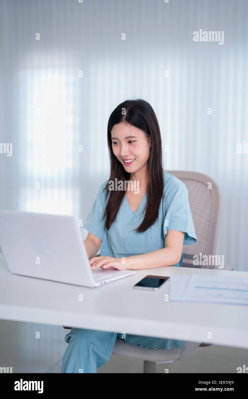 Young Asian woman healthcare professional using laptop for telemedicine ...