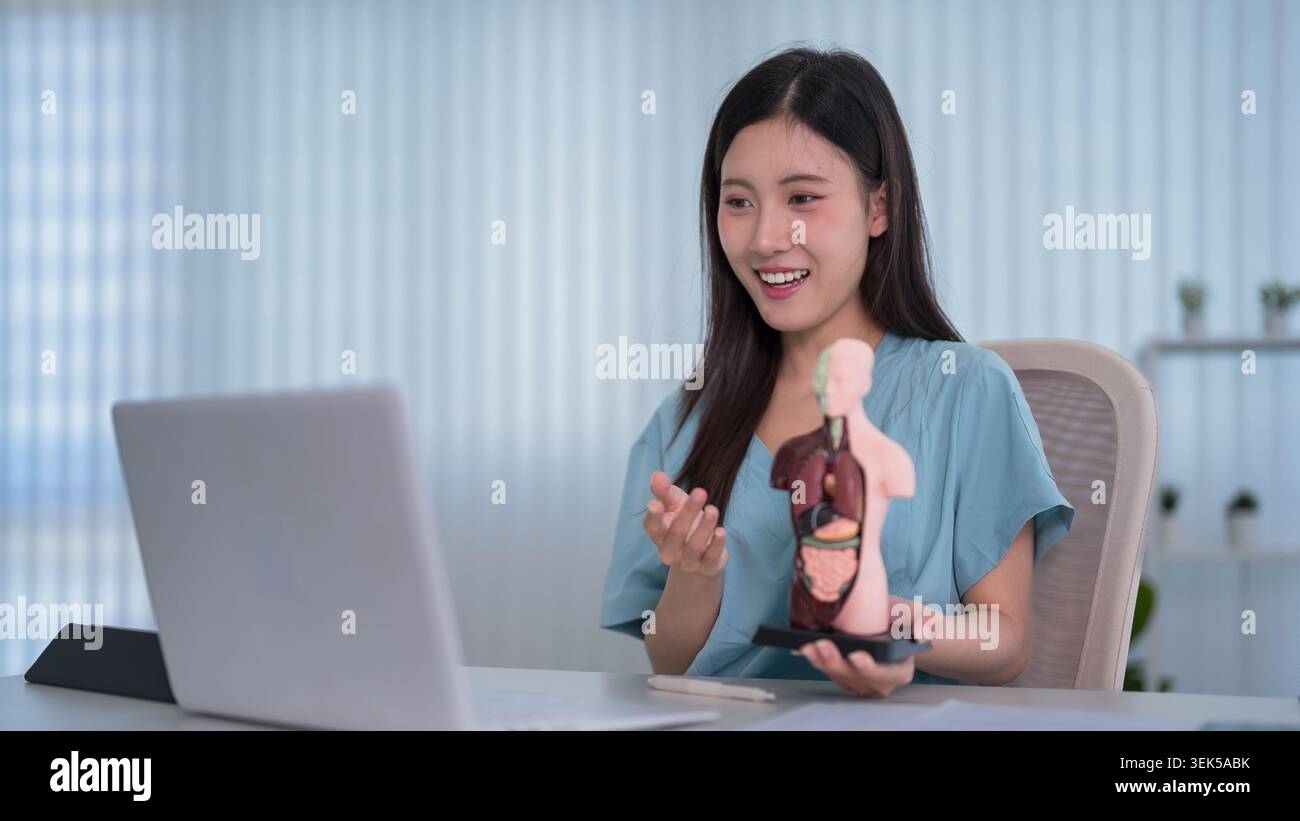 Young Asian female healthcare professional demonstrating heart anatomy ...
