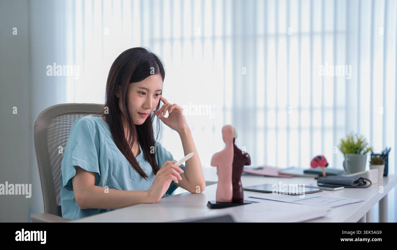 young Asian woman doctor medical professional talking phone consulting ...