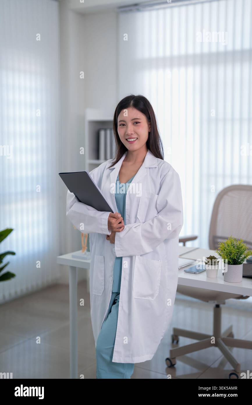 Asian women doctor holding clipboard medical record smiling ...