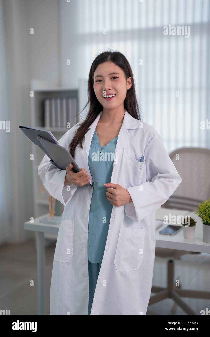 young Asian female doctor holding digital tablet smiling wearing white ...