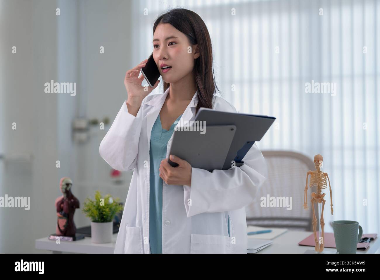 Asian woman doctor using phone tablet medical office healthcare ...